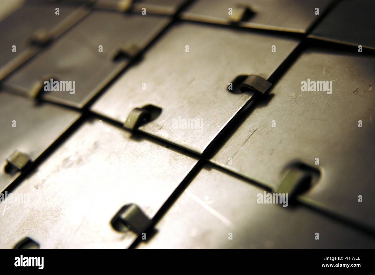 Square pieces of metal connected together, close up Stock Photo - Alamy
