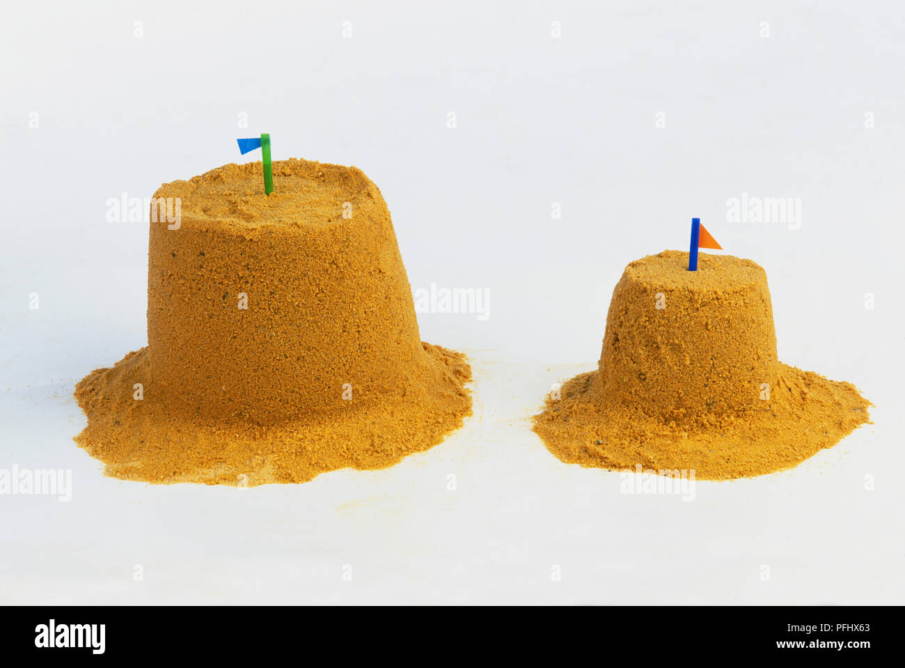 Two sand castles topped with flags, front view Stock Photo - Alamy