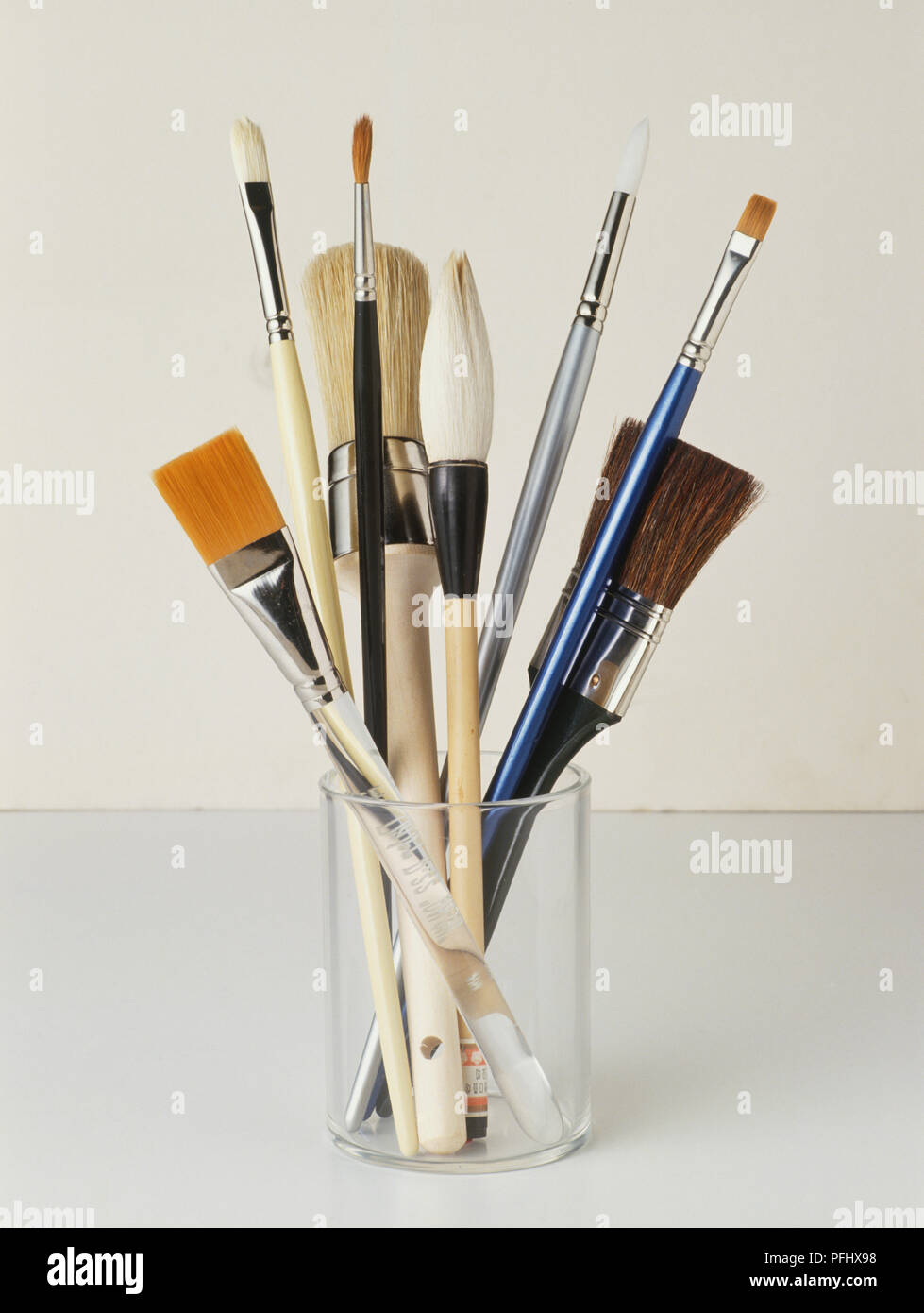 Assortment of paint brushes in glass, front view Stock Photo - Alamy