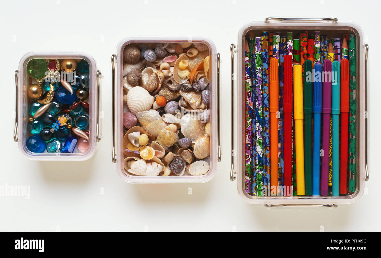 Three metal stacking boxes containing coloured felt-tip pens, sea ...