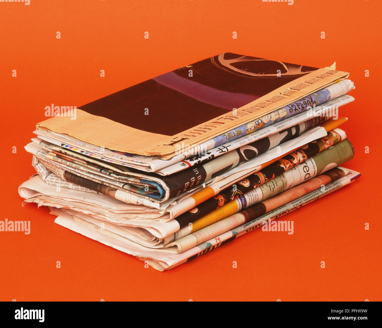 Pile of folded newspapers, front view Stock Photo - Alamy