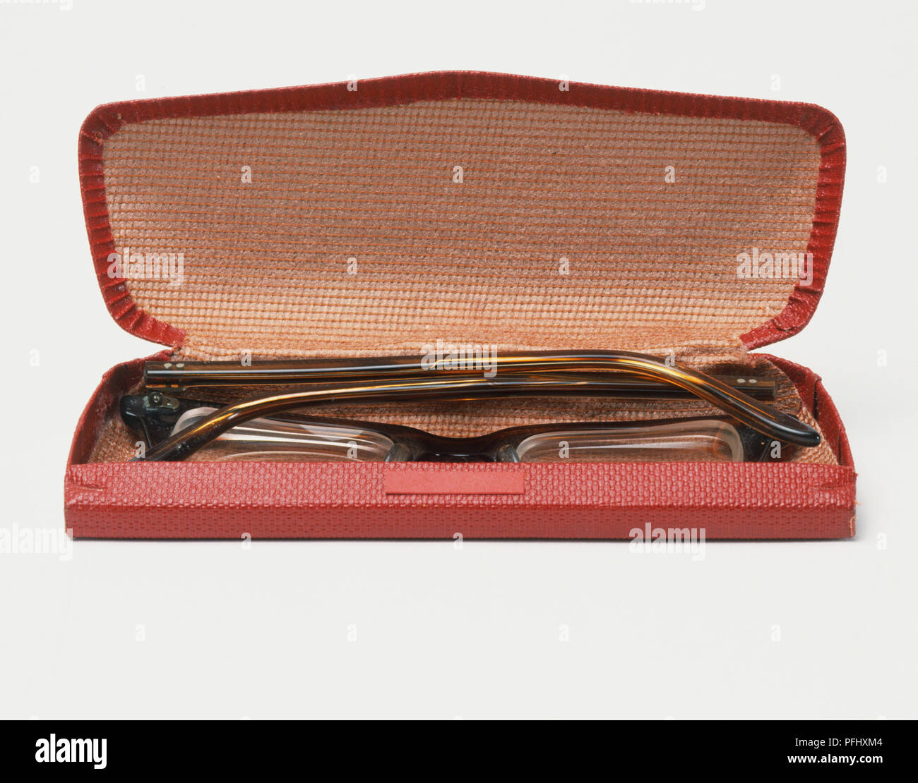 Folded spectacles with thick frames in open red case, front view Stock ...