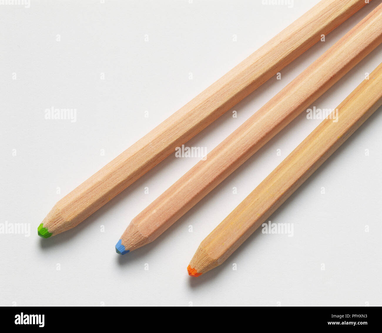 Three wooden coloured pencils, close up Stock Photo - Alamy