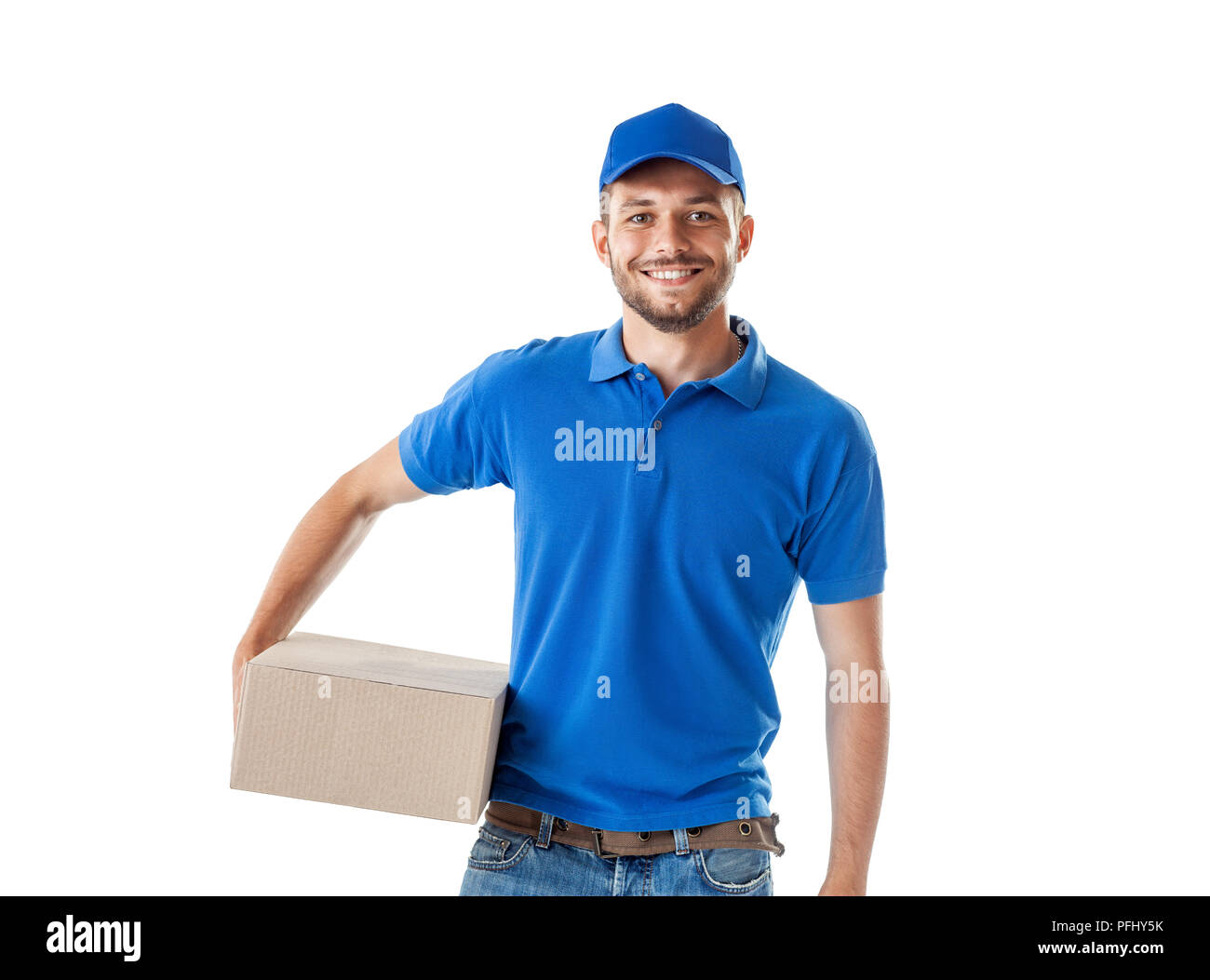 Happy young delivery man in blue uniform standing with parcel post box ...