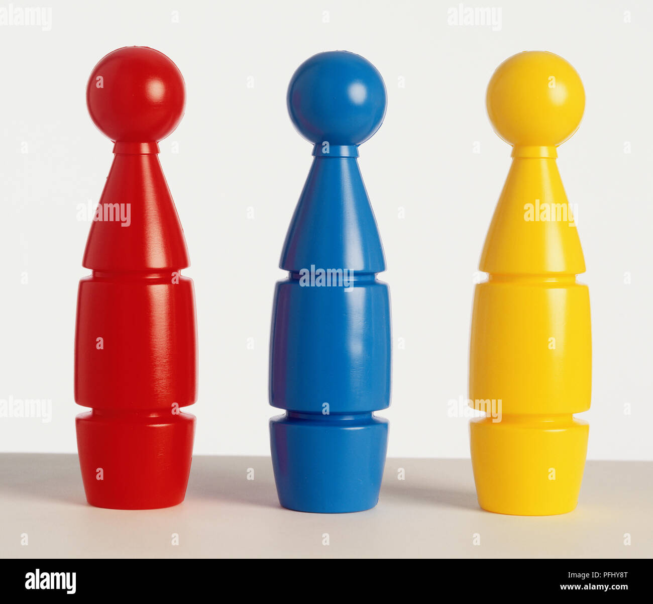 Red, blue and yellow plastic pins used in games of skittles Stock Photo ...