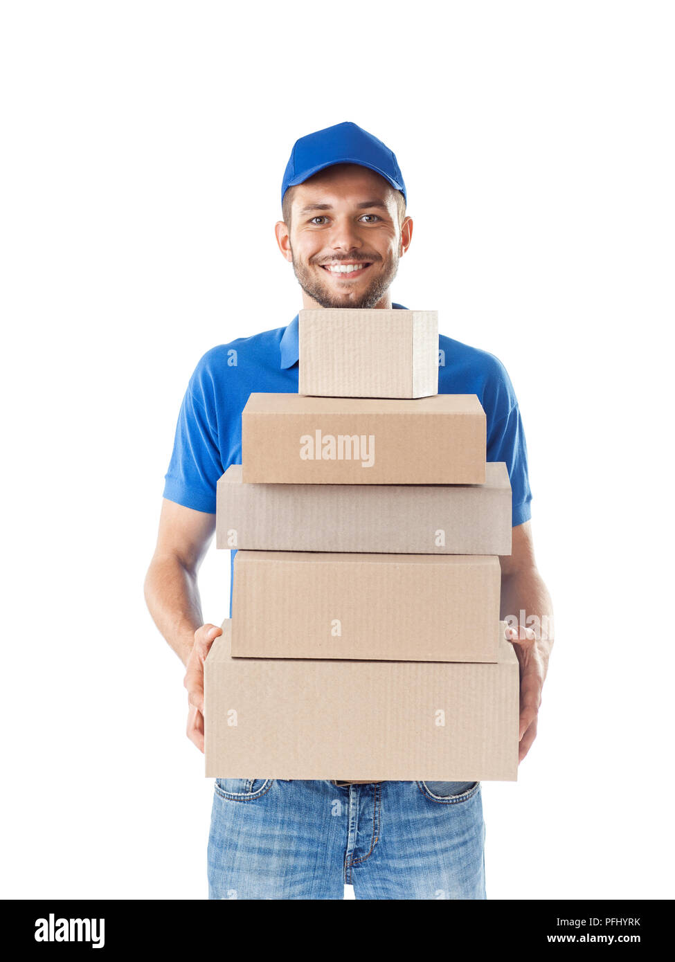 Happy delivery man in blue uniform holding pile of cardboard boxes ...