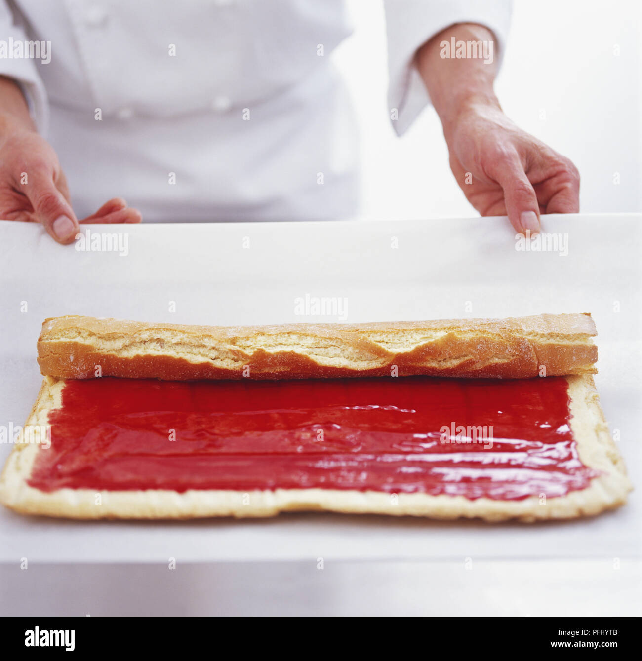 Rolling up sponge roulade Stock Photo - Alamy
