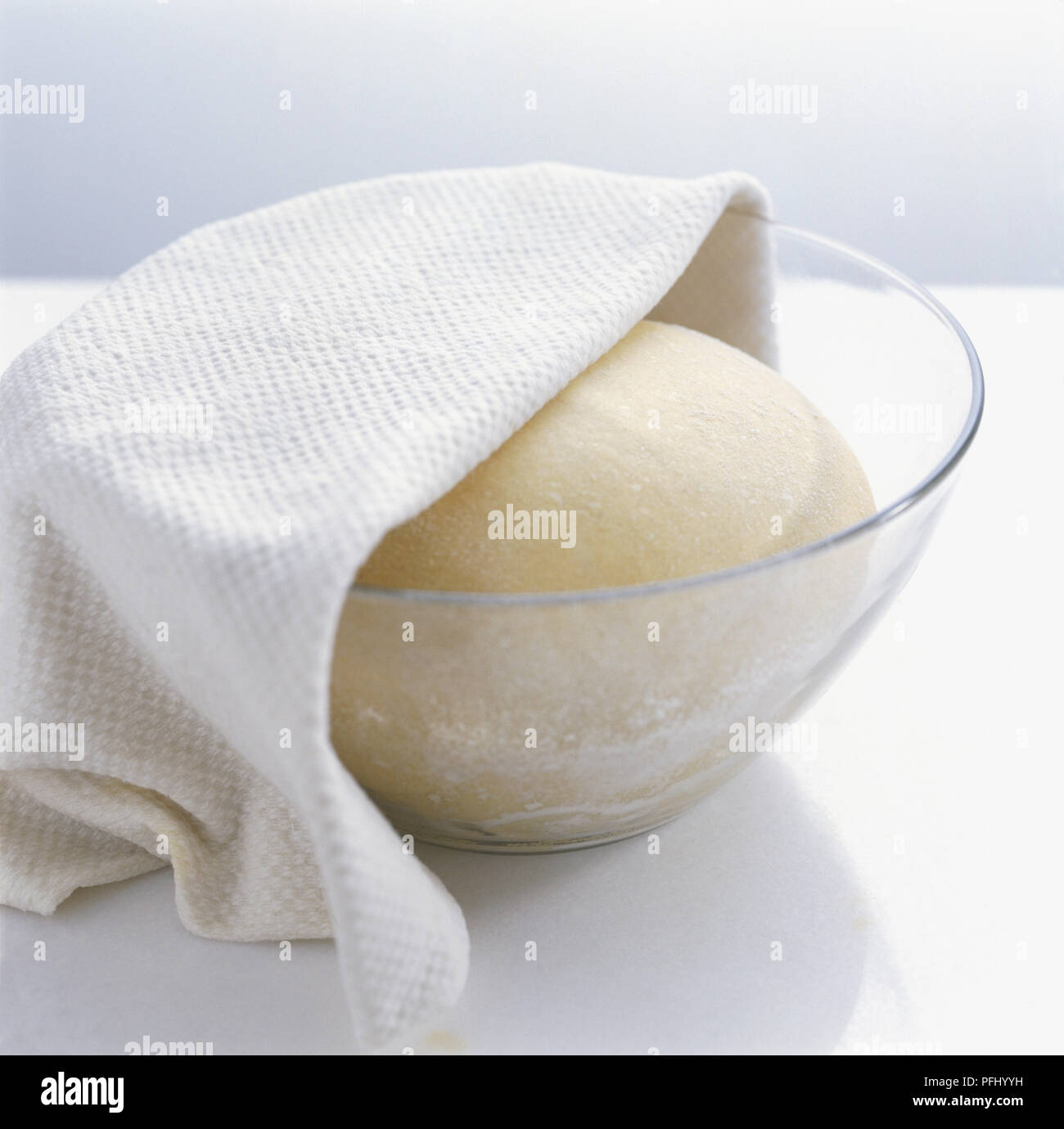Ball-shaped dough in a bowl half covered with a cloth Stock Photo - Alamy