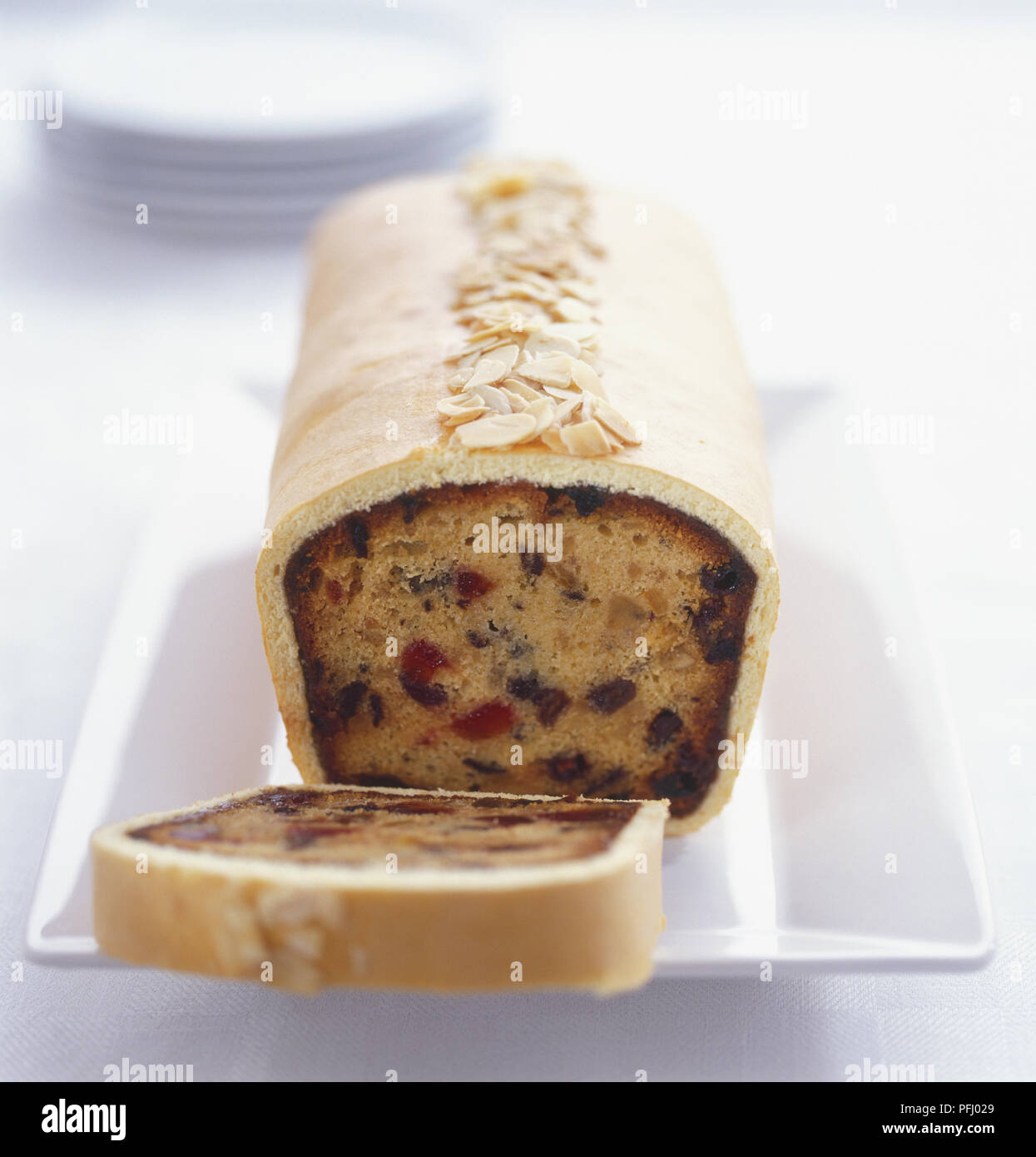 Rich fruit loaf with a slice removed, front view Stock Photo - Alamy