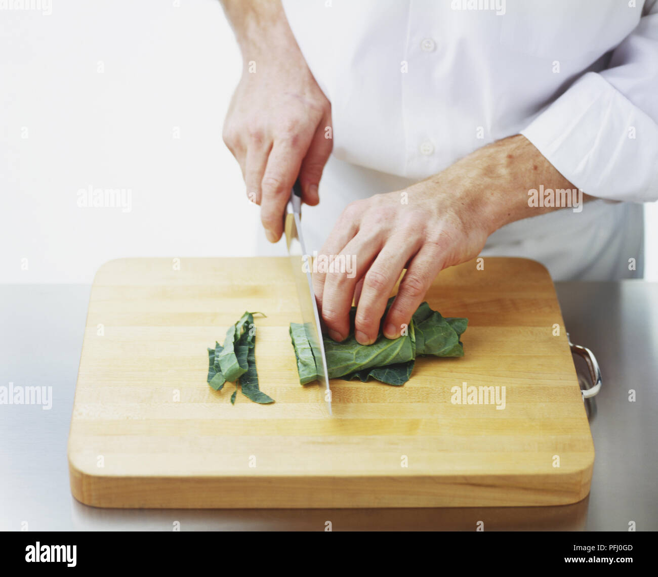 Cutting green leaf vegetable into strips Stock Photo - Alamy