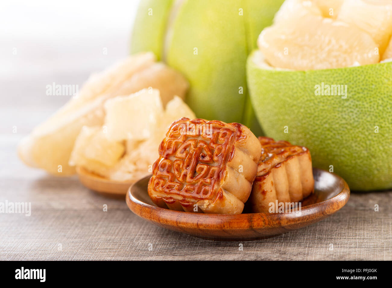 fresh and peeled pomelo(shaddock), grapefruit with slices and mooncake ...