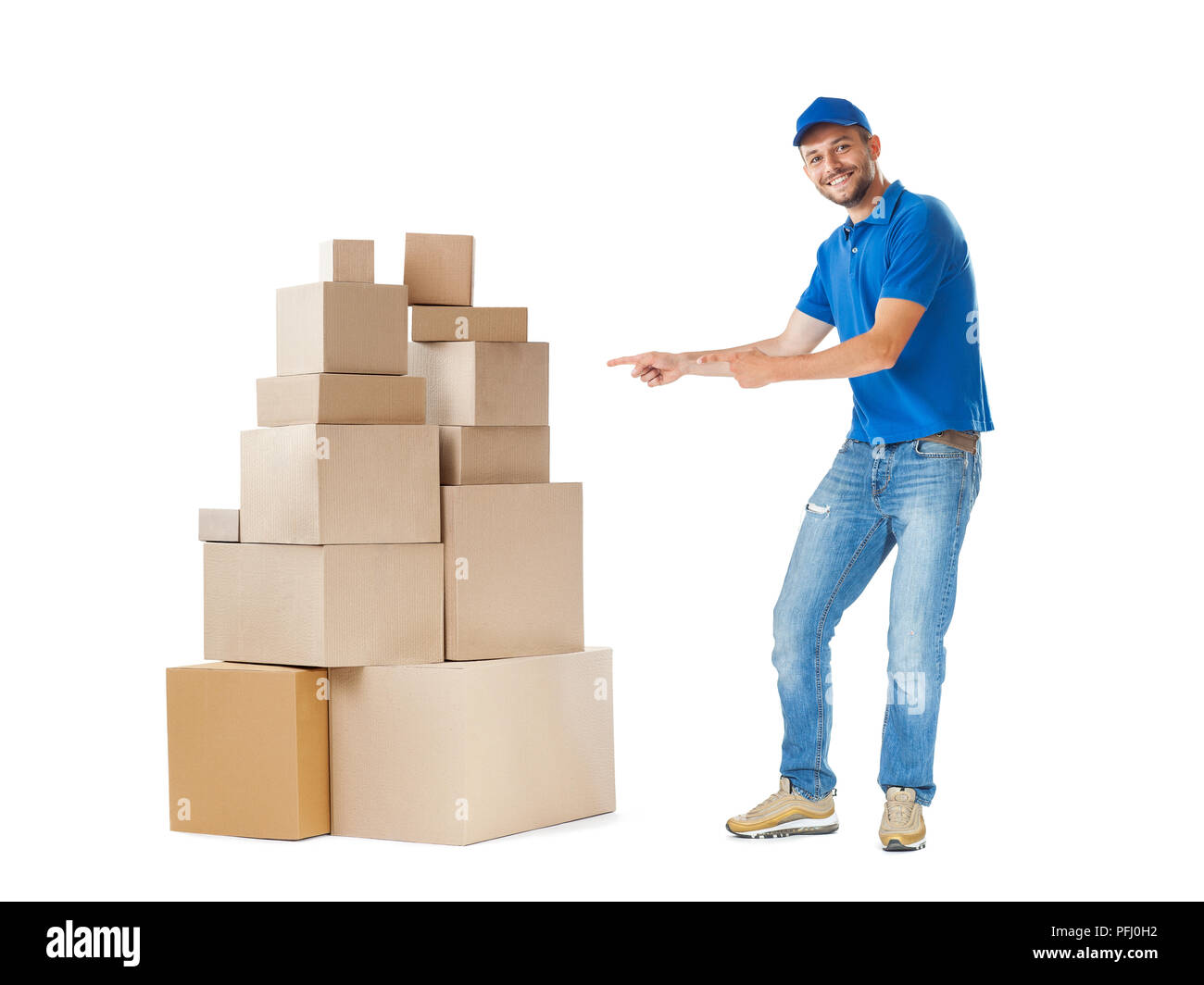 Delivery man pointing to stack of boxes isolated on white background ...