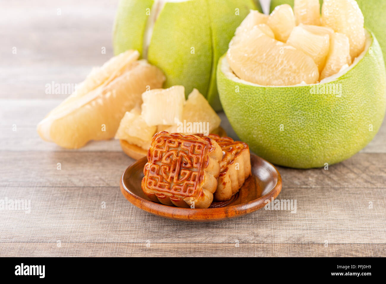 fresh and peeled pomelo(shaddock), grapefruit with slices and mooncake ...