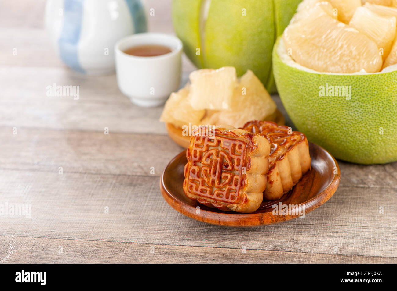 fresh and peeled pomelo(shaddock), grapefruit with slices and mooncake ...