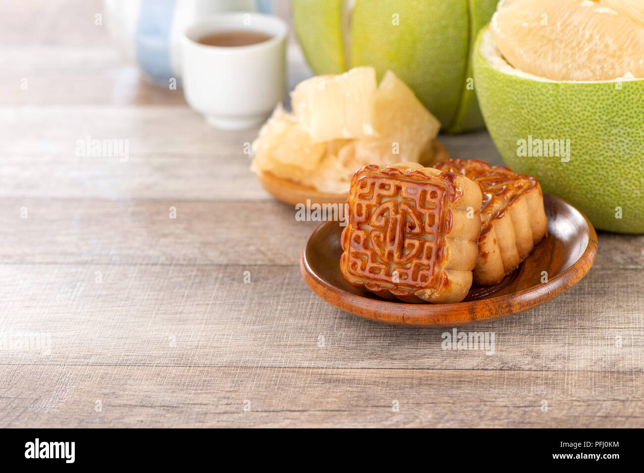 fresh and peeled pomelo(shaddock), grapefruit with slices and mooncake ...