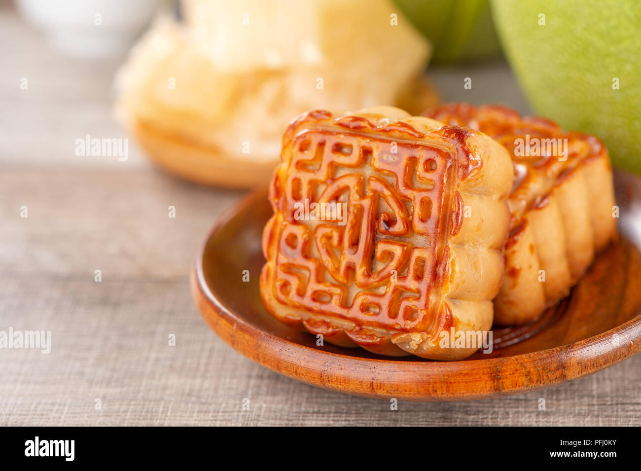 fresh and peeled pomelo(shaddock), grapefruit with slices and mooncake ...