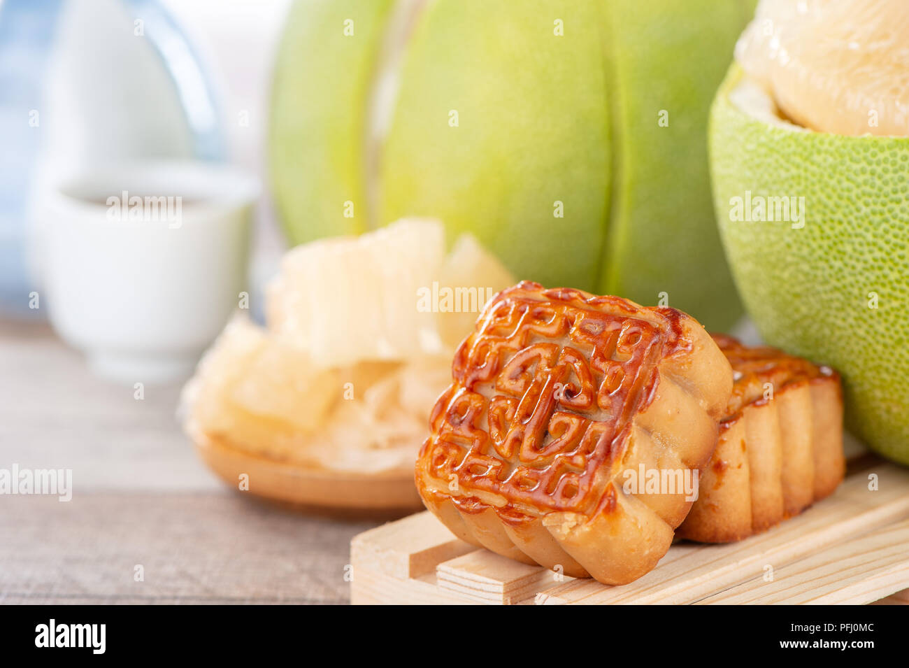 fresh and peeled pomelo(shaddock), grapefruit with slices and mooncake ...