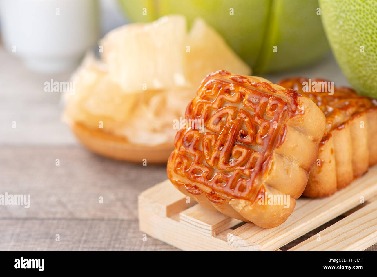 fresh and peeled pomelo(shaddock), grapefruit with slices and mooncake ...