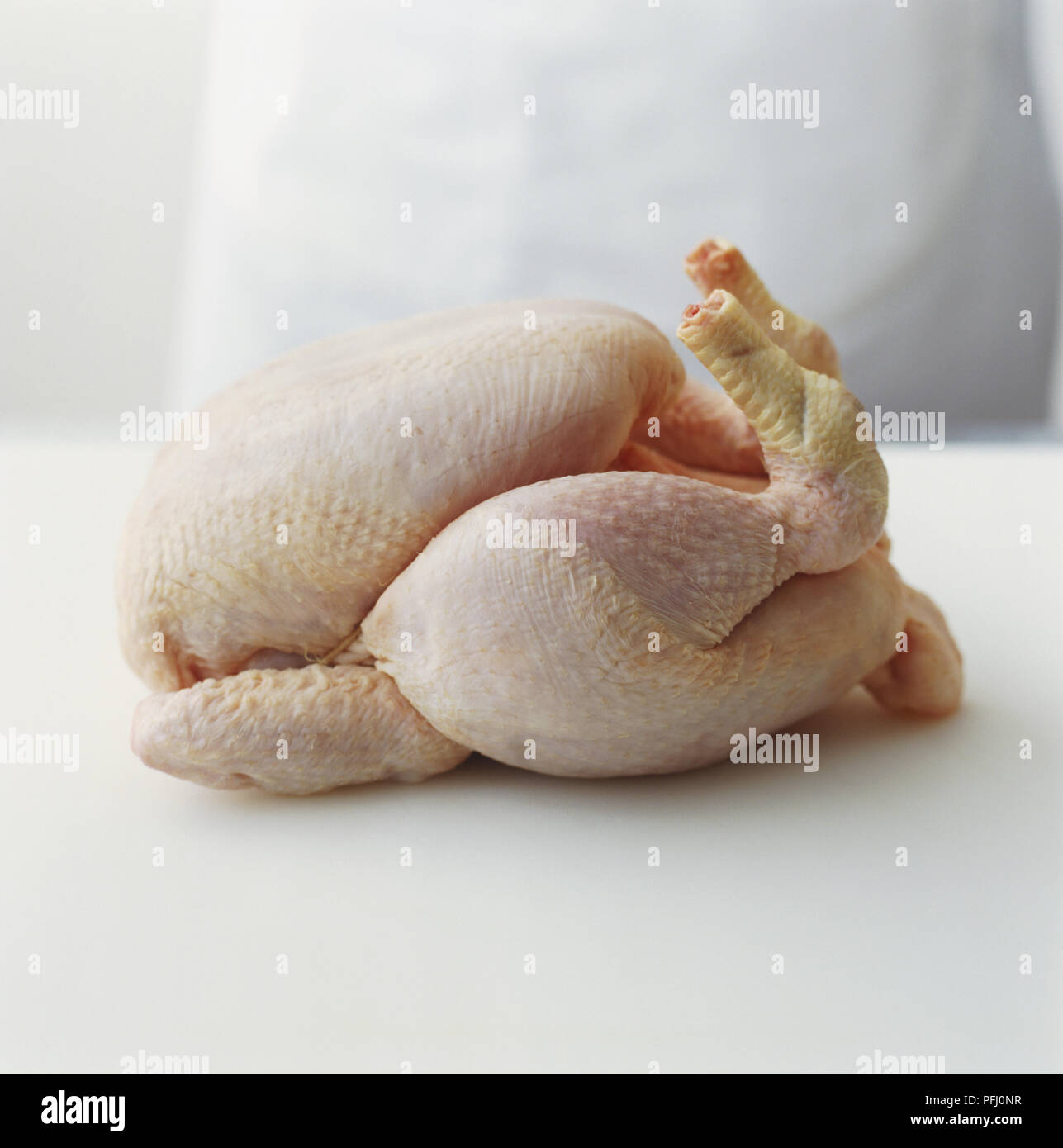 Whole raw chicken, side view Stock Photo - Alamy