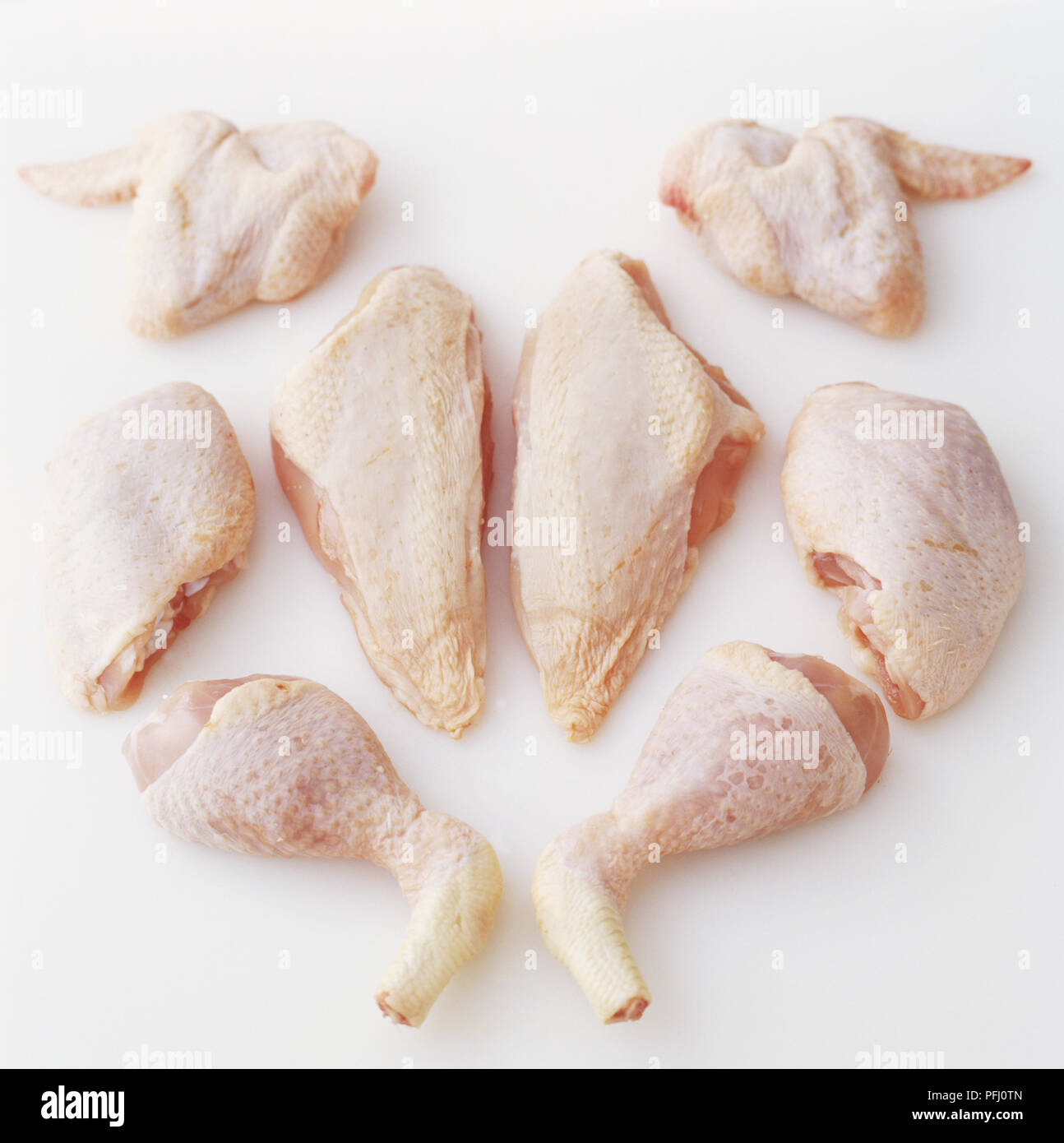 Raw chicken cut into eight pieces Stock Photo - Alamy