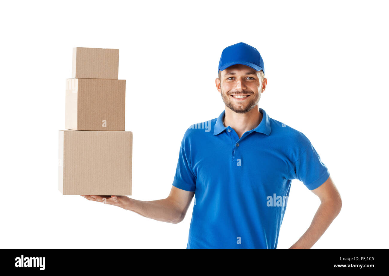 Smiling delivery man holding pile of cardboard boxes isolated on white ...