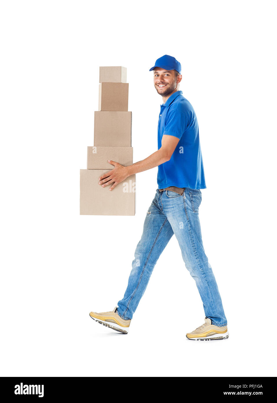 Full length profile portrait of courier walking and carrying stack of ...
