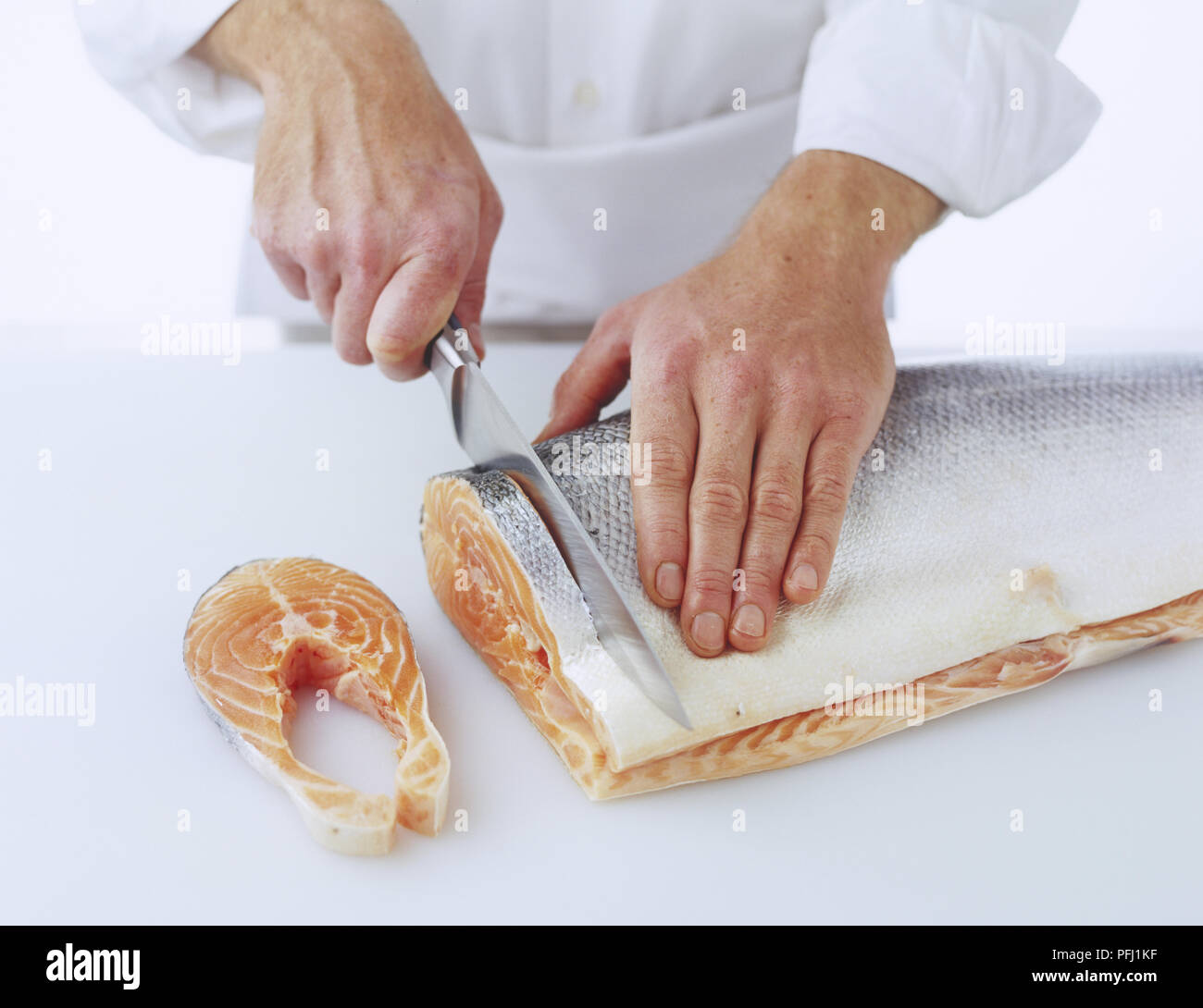Cutting a salmon into steaks Stock Photo - Alamy