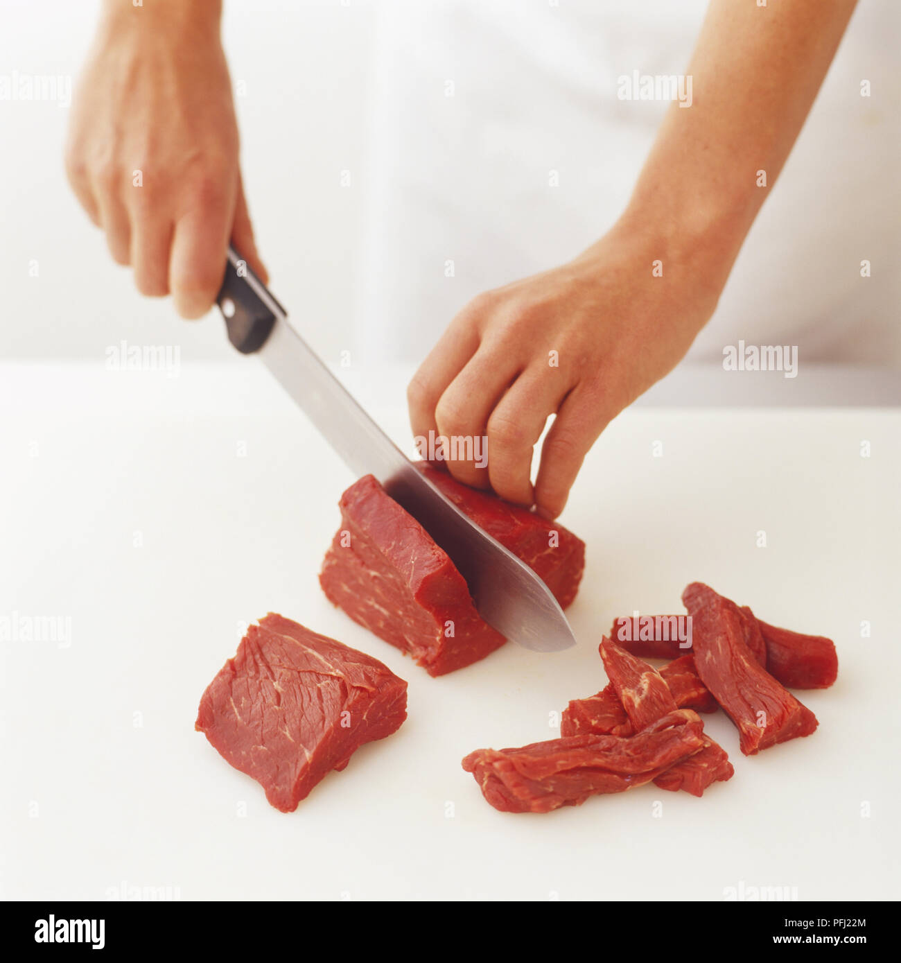 Cutting a fillet steak into strips Stock Photo - Alamy