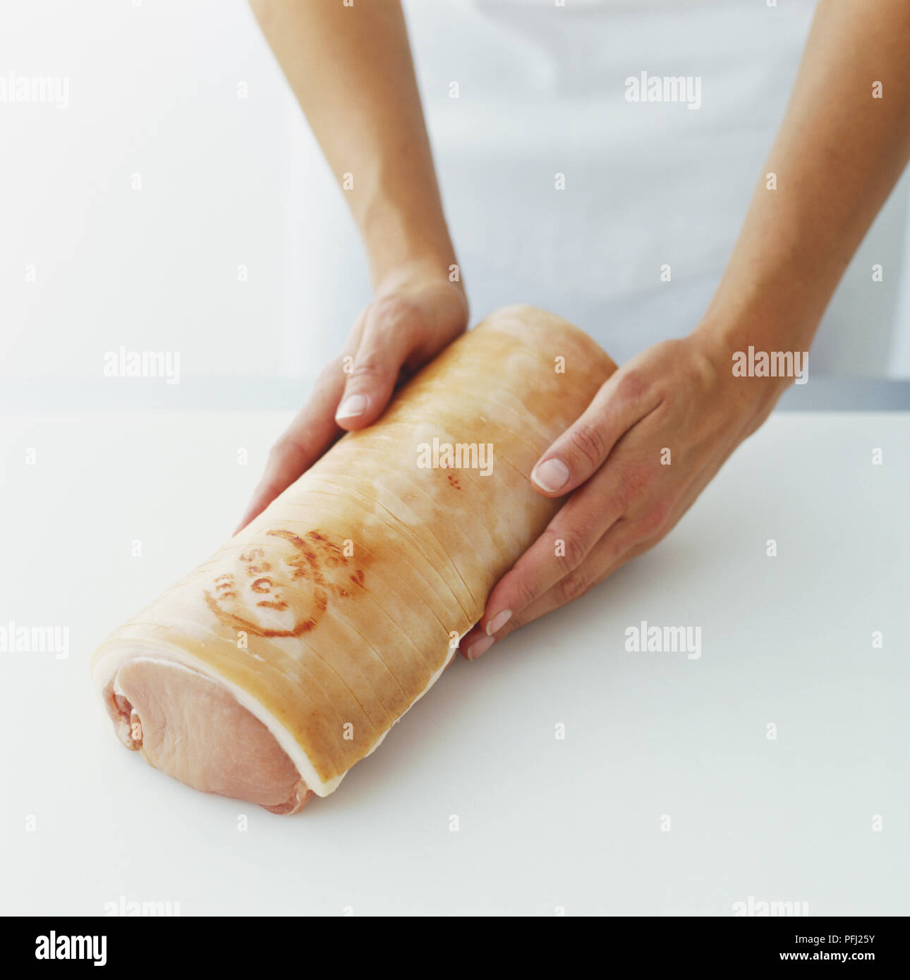 Using hands to form boned pork loin into sausage shape Stock Photo - Alamy