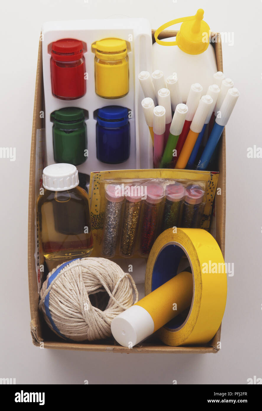 Box containing colour pens, paint, glitter, string, glue and tape Stock ...