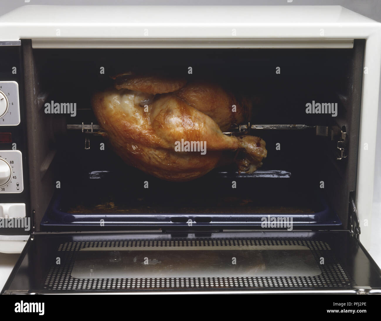 Chicken being cooked on a spit Stock Photo - Alamy