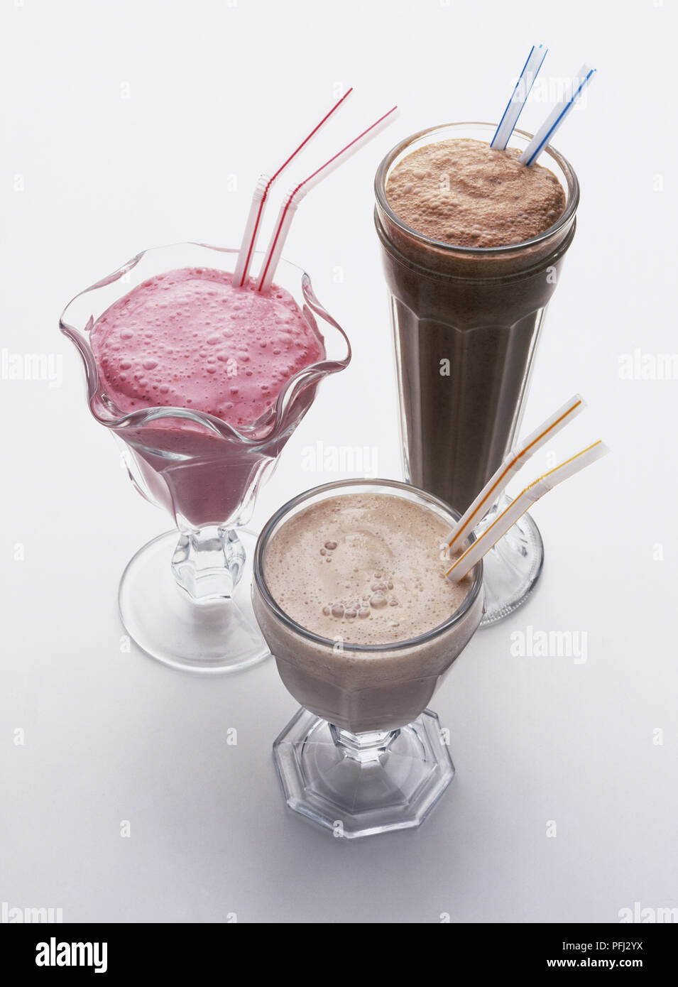 Three different flavoured milkshakes, raspberry, elevated view Stock ...