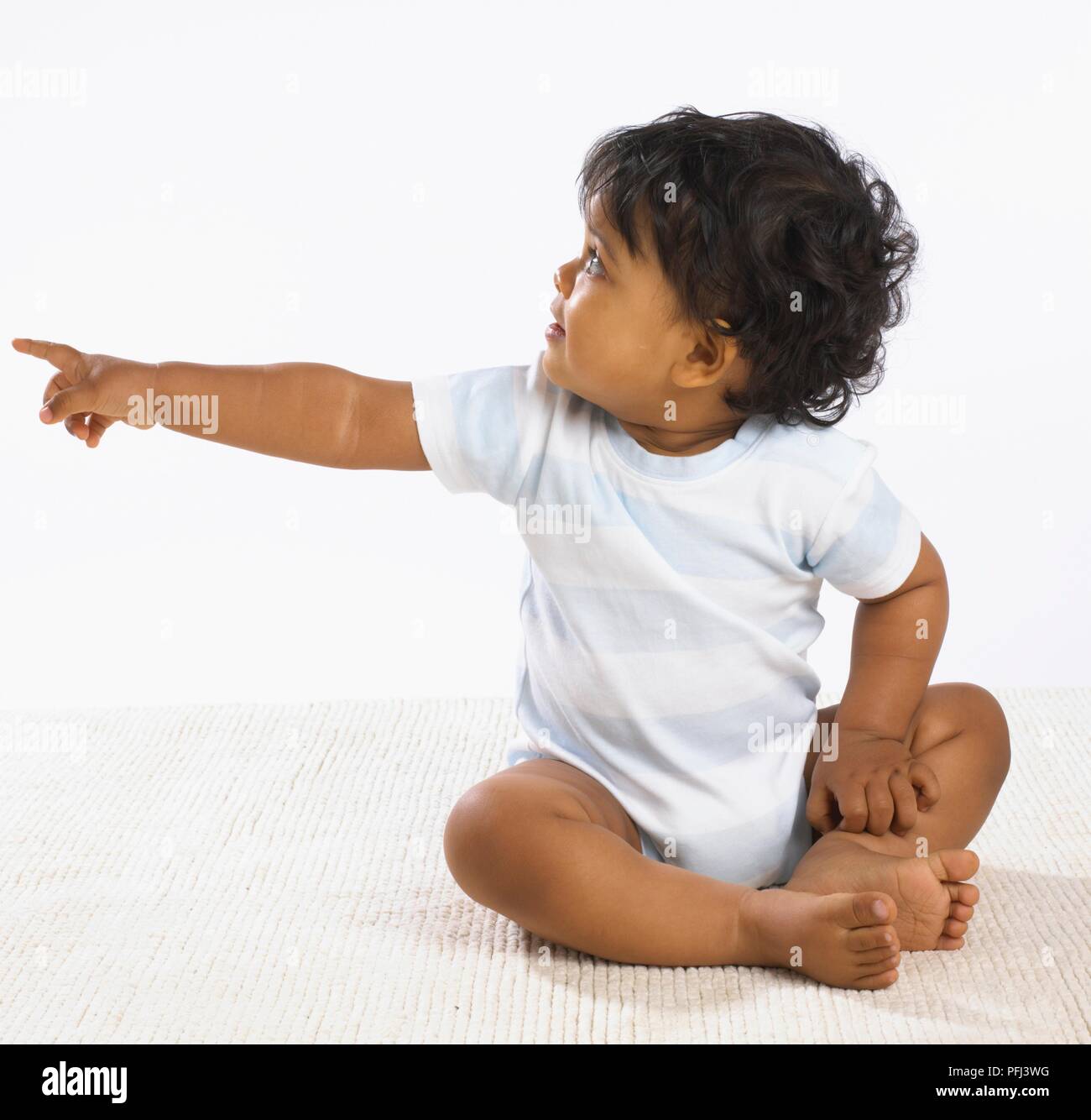 Baby boy looking to side, pointing Stock Photo - Alamy
