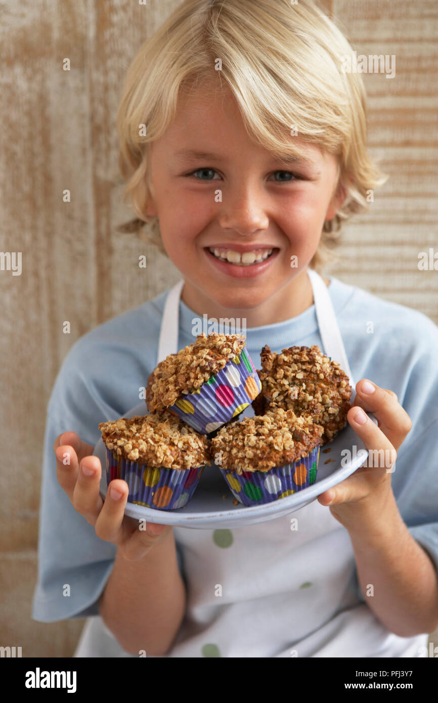 Boy with muffins Stock Photo - Alamy