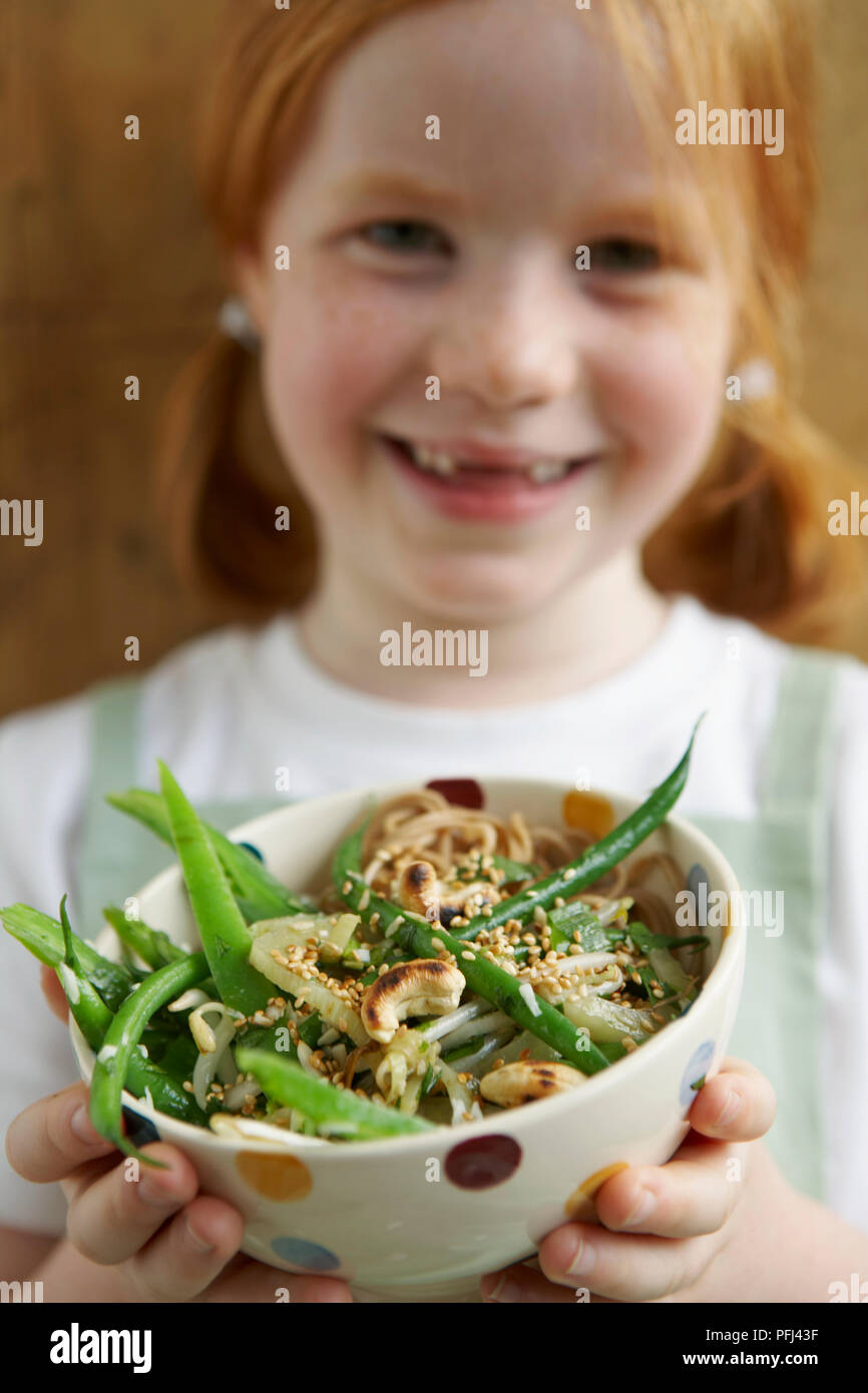 Girl with bean stir-fry Stock Photo - Alamy