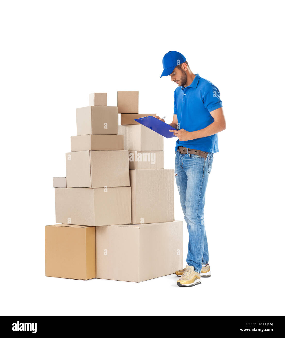 Delivery man taking notes near stack of parcels boxes isolated on white ...