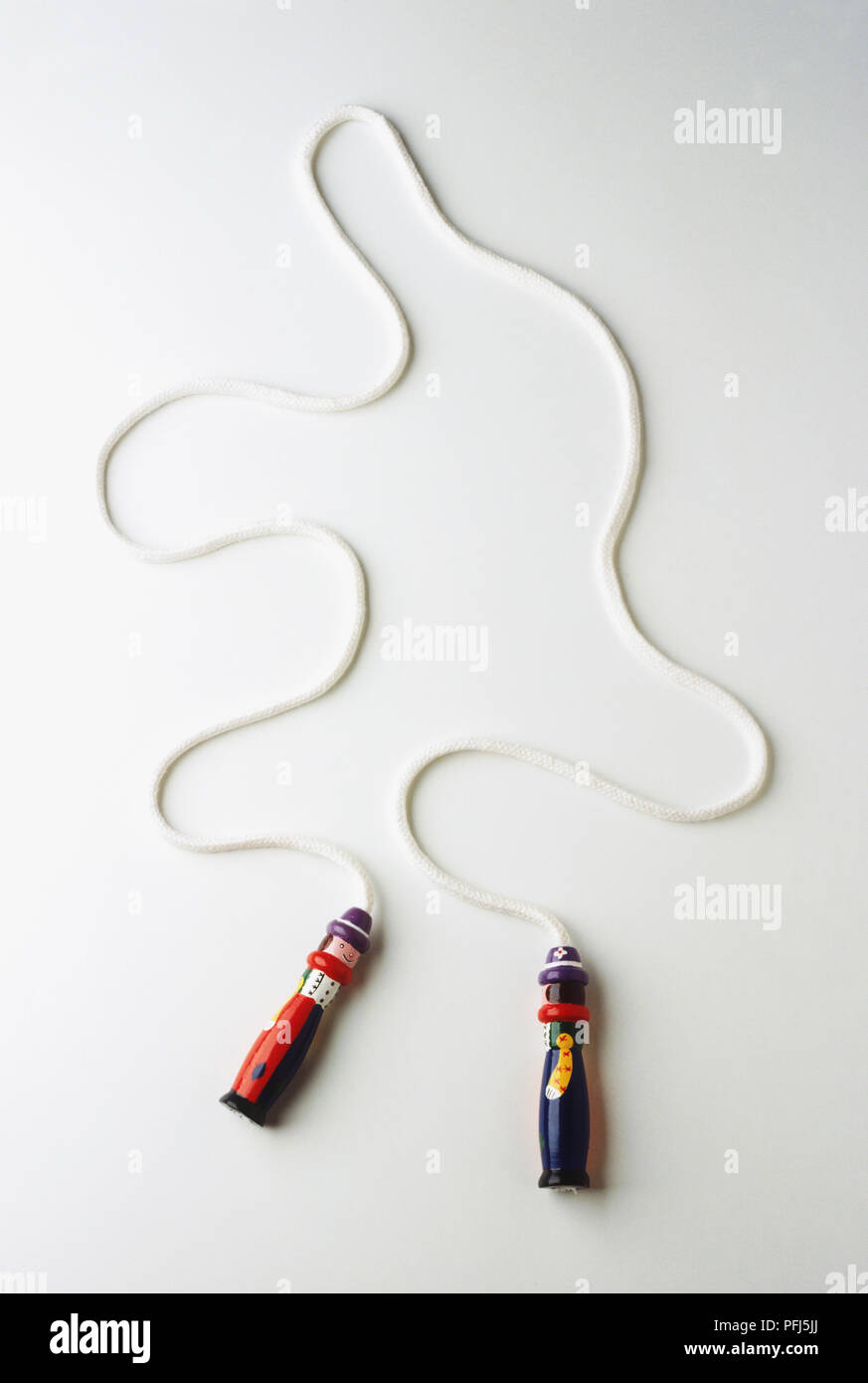 Skipping rope with painted wooden figurines at either end Stock Photo ...