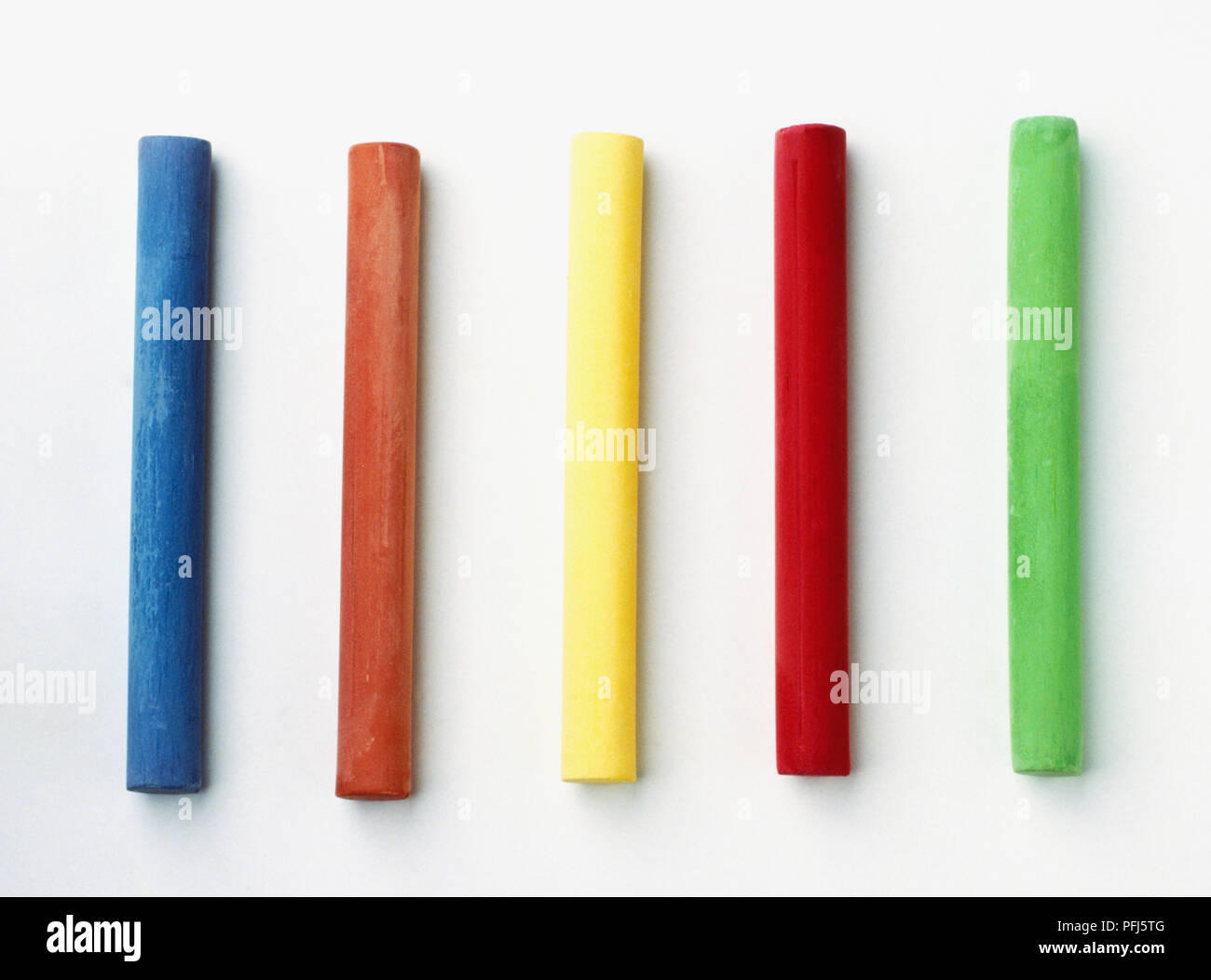 Five coloured chalks, blue, red, yellow and green Stock Photo - Alamy