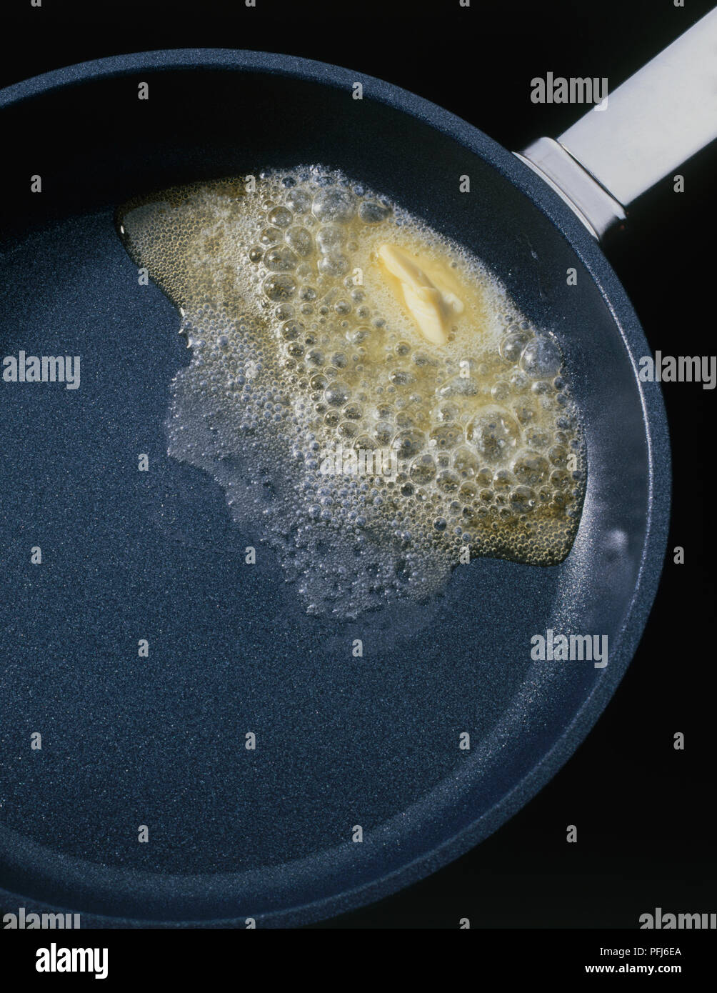 Butter melting in a frying pan, view from above Stock Photo - Alamy