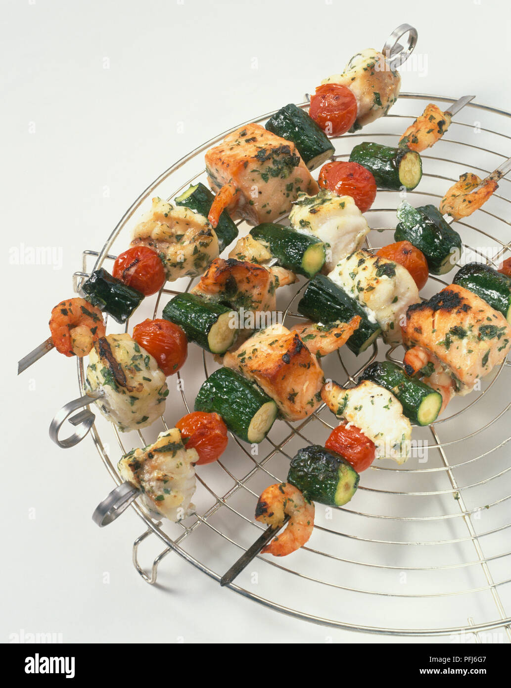 Grilled seafood kebabs on a grill rack Stock Photo - Alamy