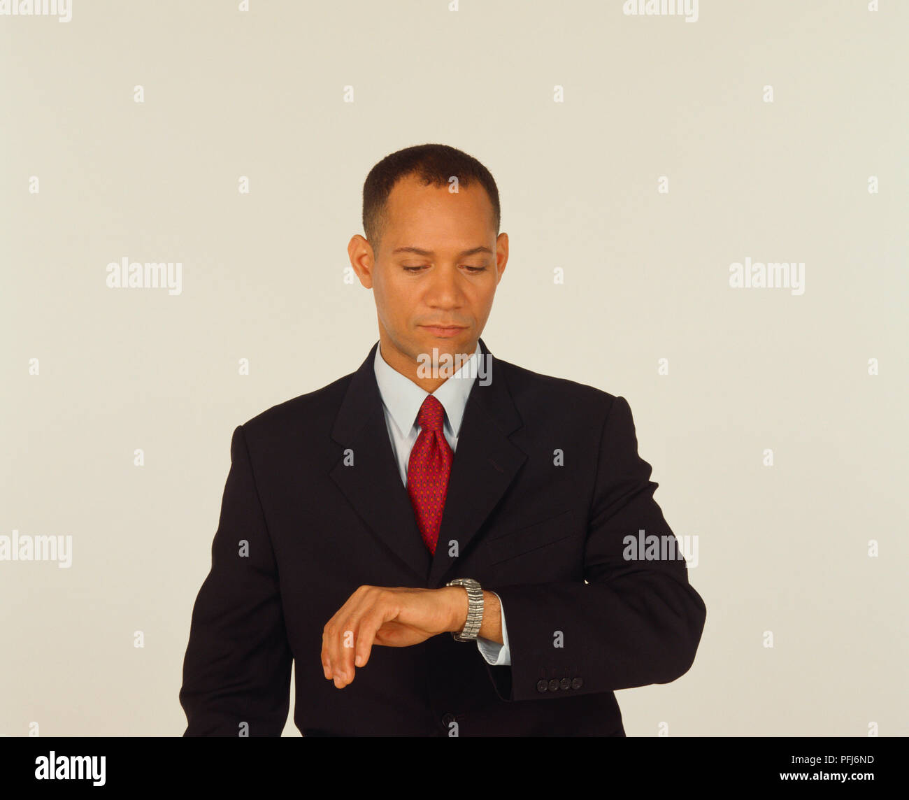 Standing man in business suit looking at his watch, front view Stock ...