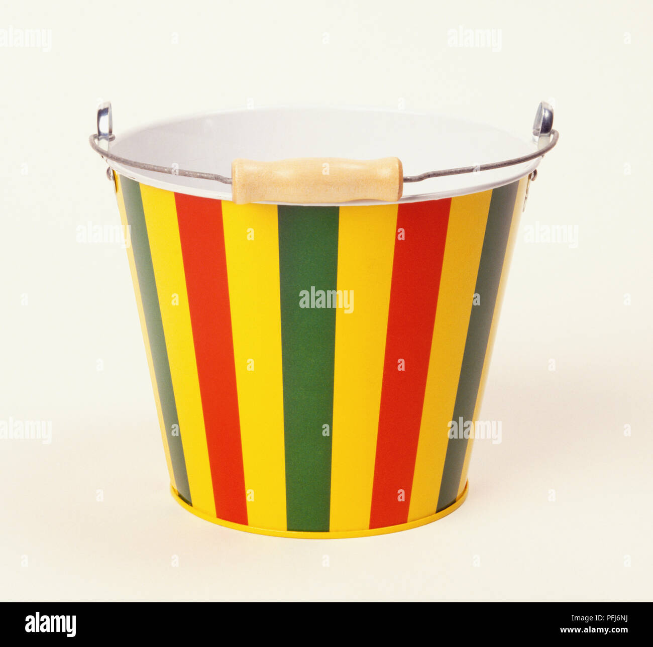 A yellow, green and red stripy bucket Stock Photo - Alamy