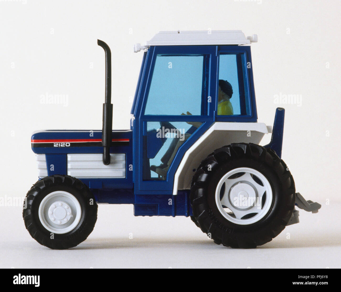 Blue toy tractor, side view Stock Photo - Alamy