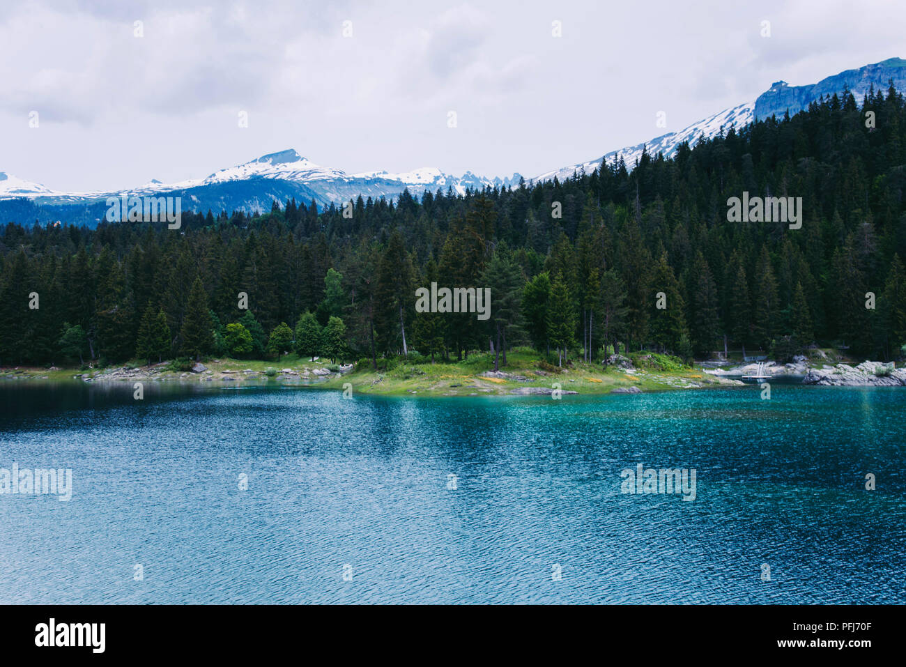 Caumasee lake with a small island located in the middle of the crystal ...