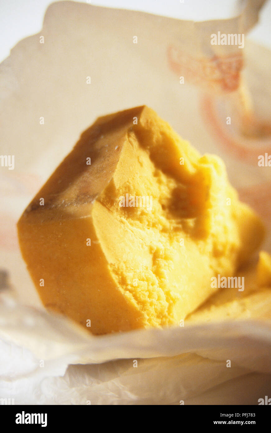 Block of parmesan cheese on unfolded paper wrapper, close up Stock ...