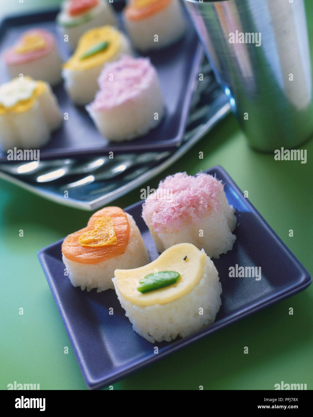 Sushi rice shapes garnished with colourful toppings, close up Stock ...