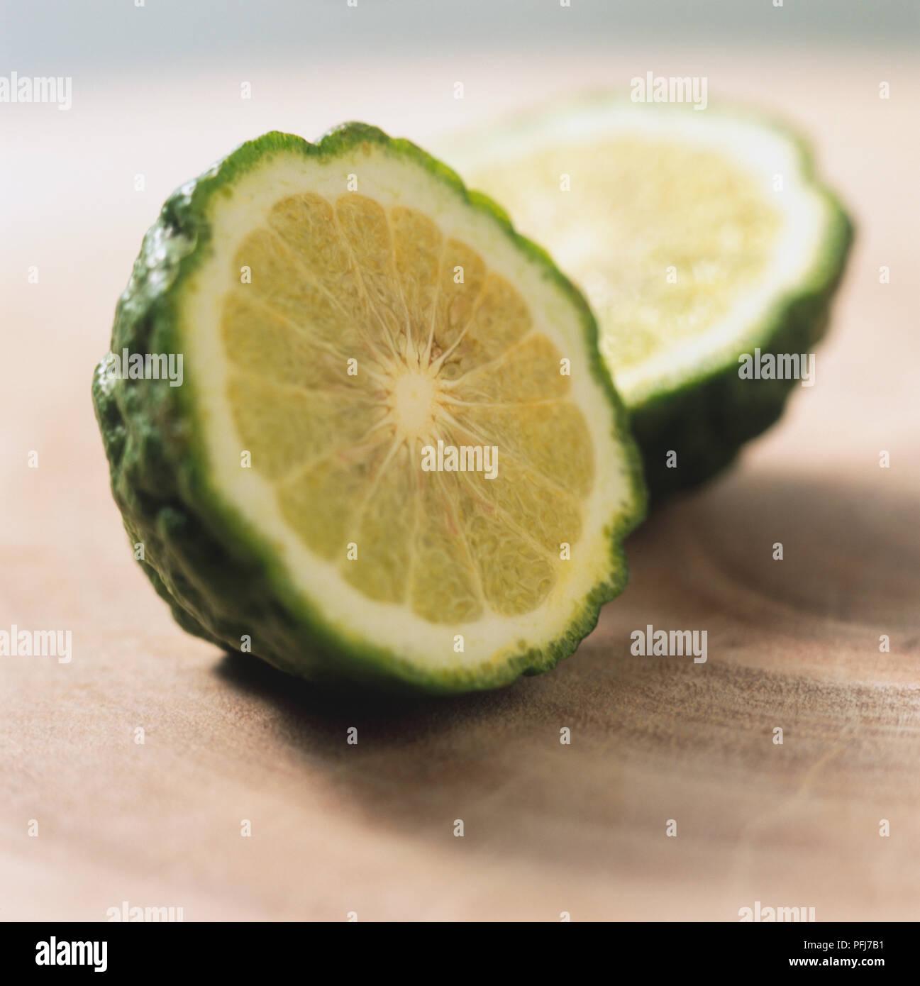 Citrus hystrix, Kaffir Lime, two halves, focus on front half, green ...