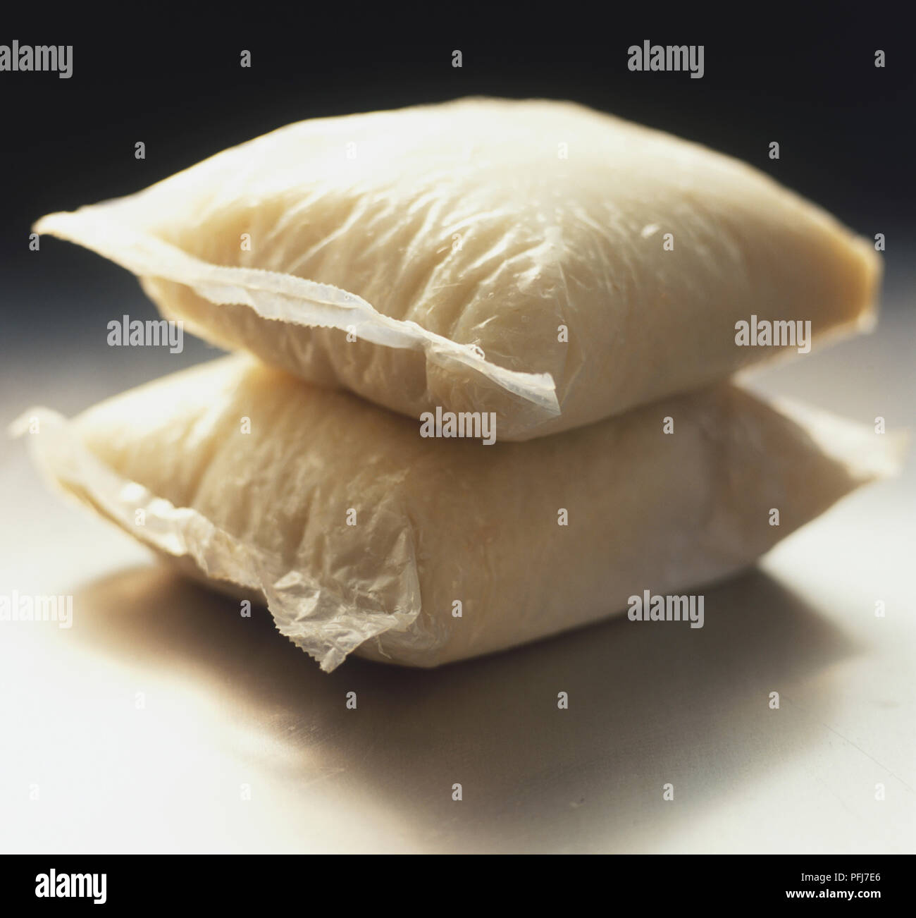 Two bags of boiled long-grain rice Stock Photo - Alamy