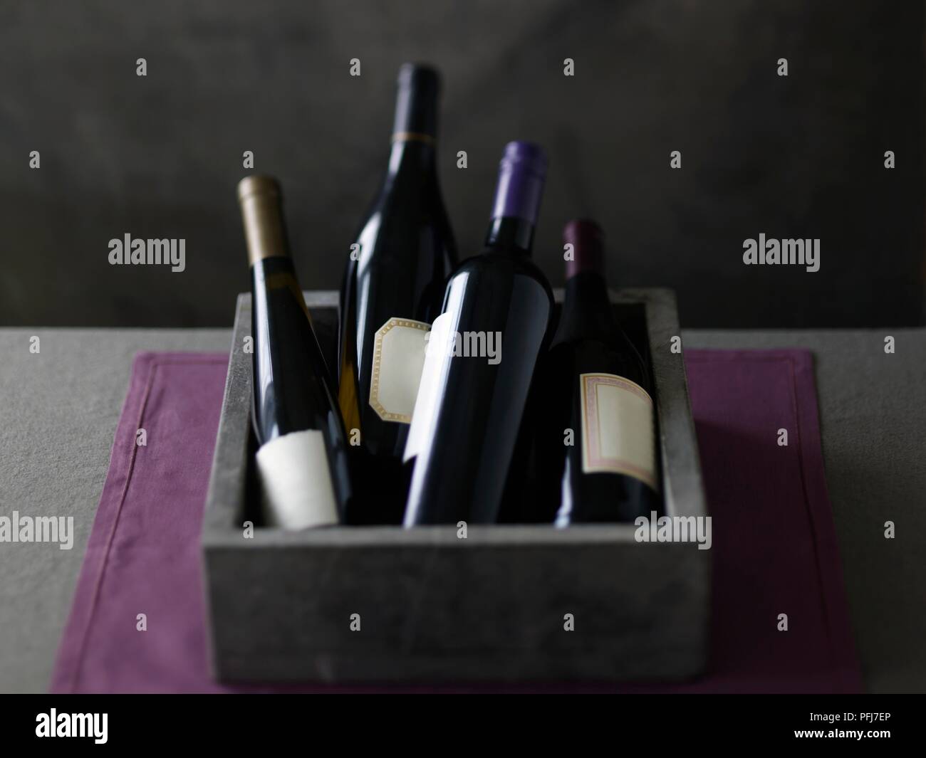 Four bottles of red wine in a box Stock Photo - Alamy