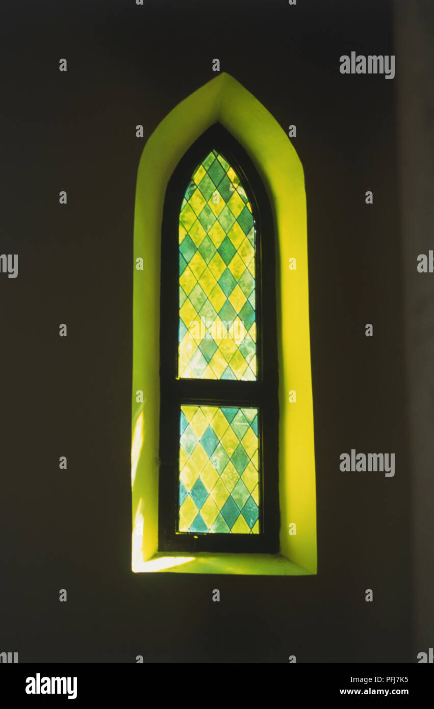 Oval window, set in thick wall, light coming through lozenge shaped ...